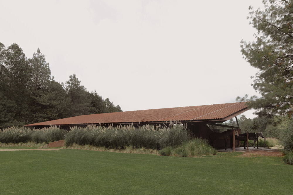 rustic horse stable by módica ledezma blends into its lush mexican setting