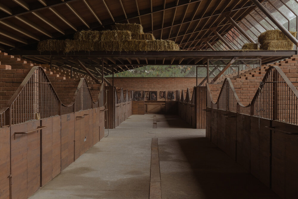 rustic horse stable by módica ledezma blends into its lush mexican setting