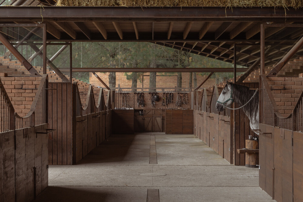 rustic horse stable by módica ledezma blends into its lush mexican setting