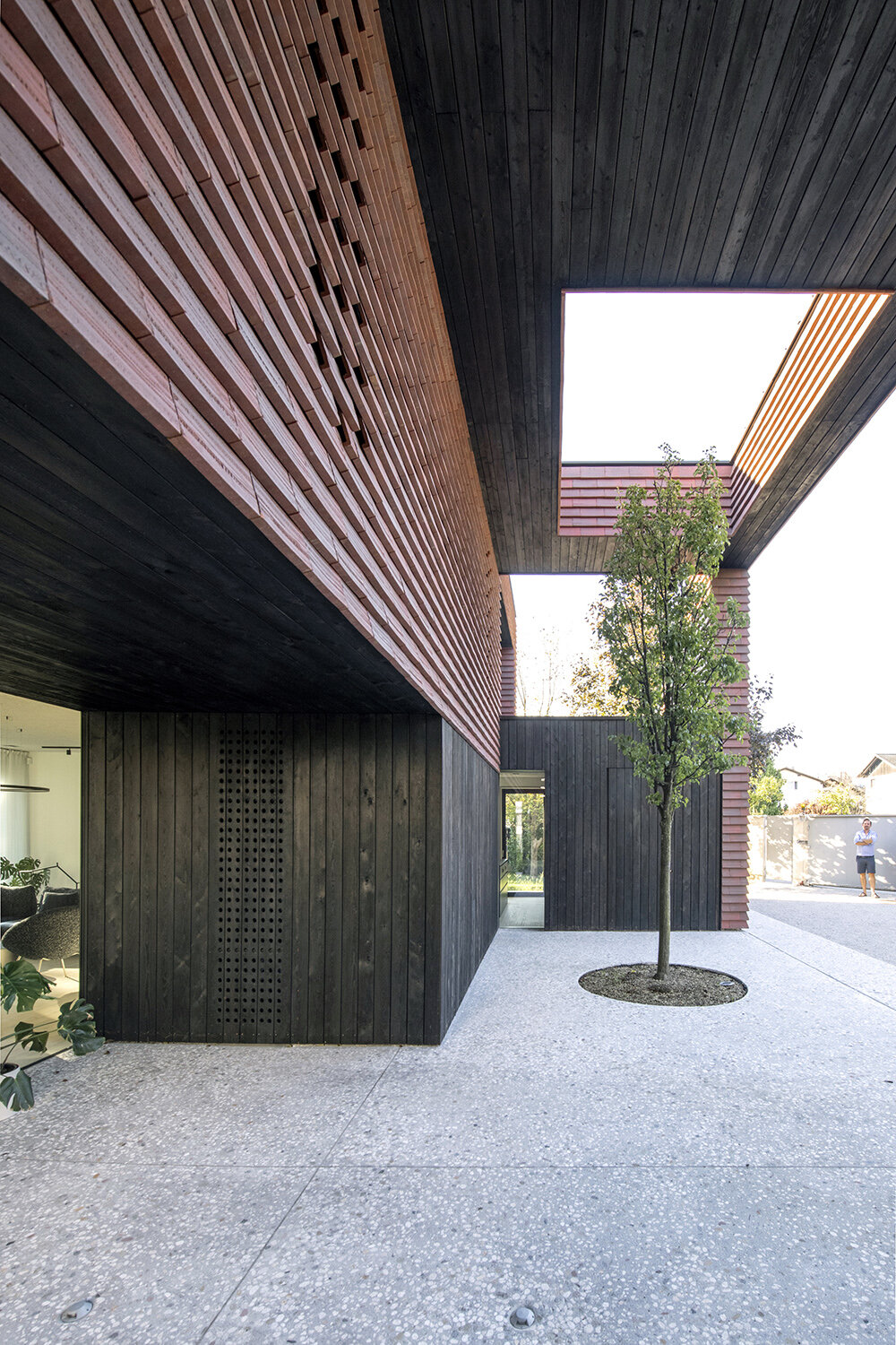 brick-tiled canopy doubles as playground for OFIS frame house in slovenia