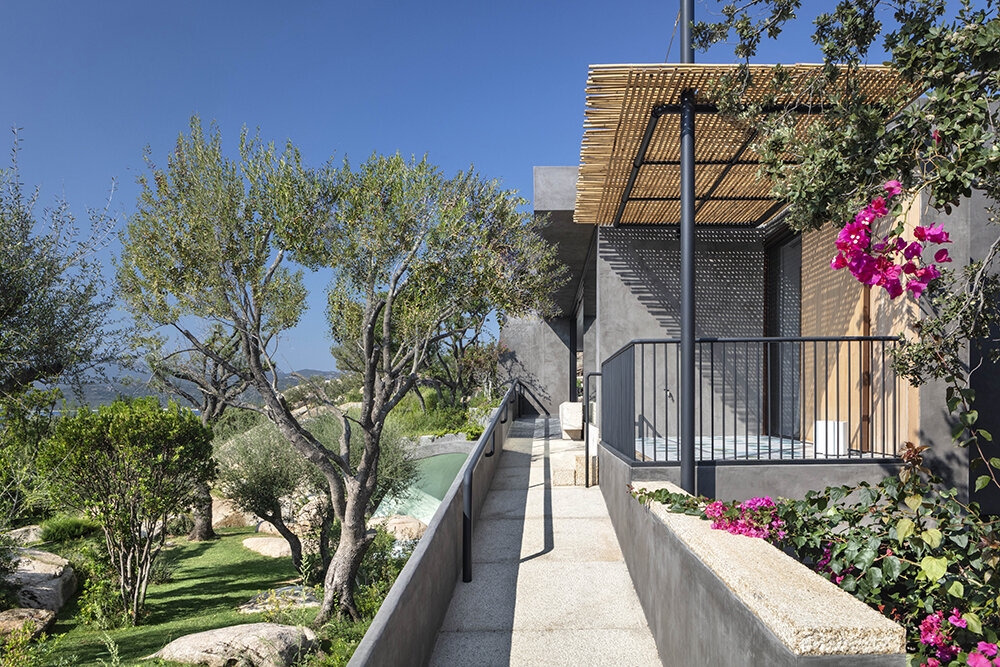 a house in sardinia by stefania stera rises as a monolith of granite & lava stone