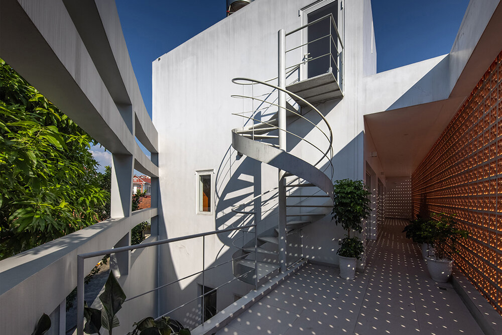 perforated double-skin brick facade shields grand house in vietnam