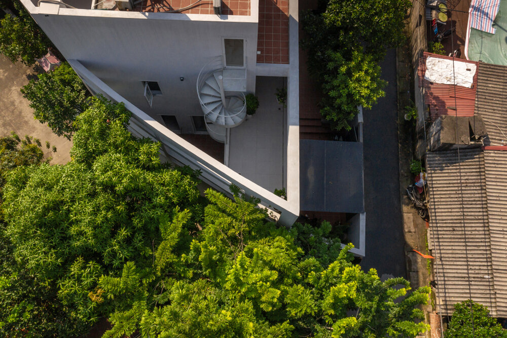 perforated double-skin brick facade shields grand house in vietnam
