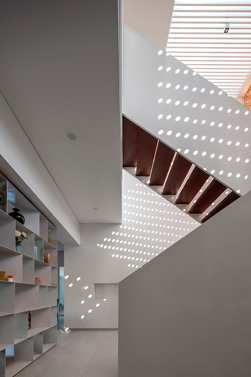 perforated double-skin brick facade shields grand house in vietnam