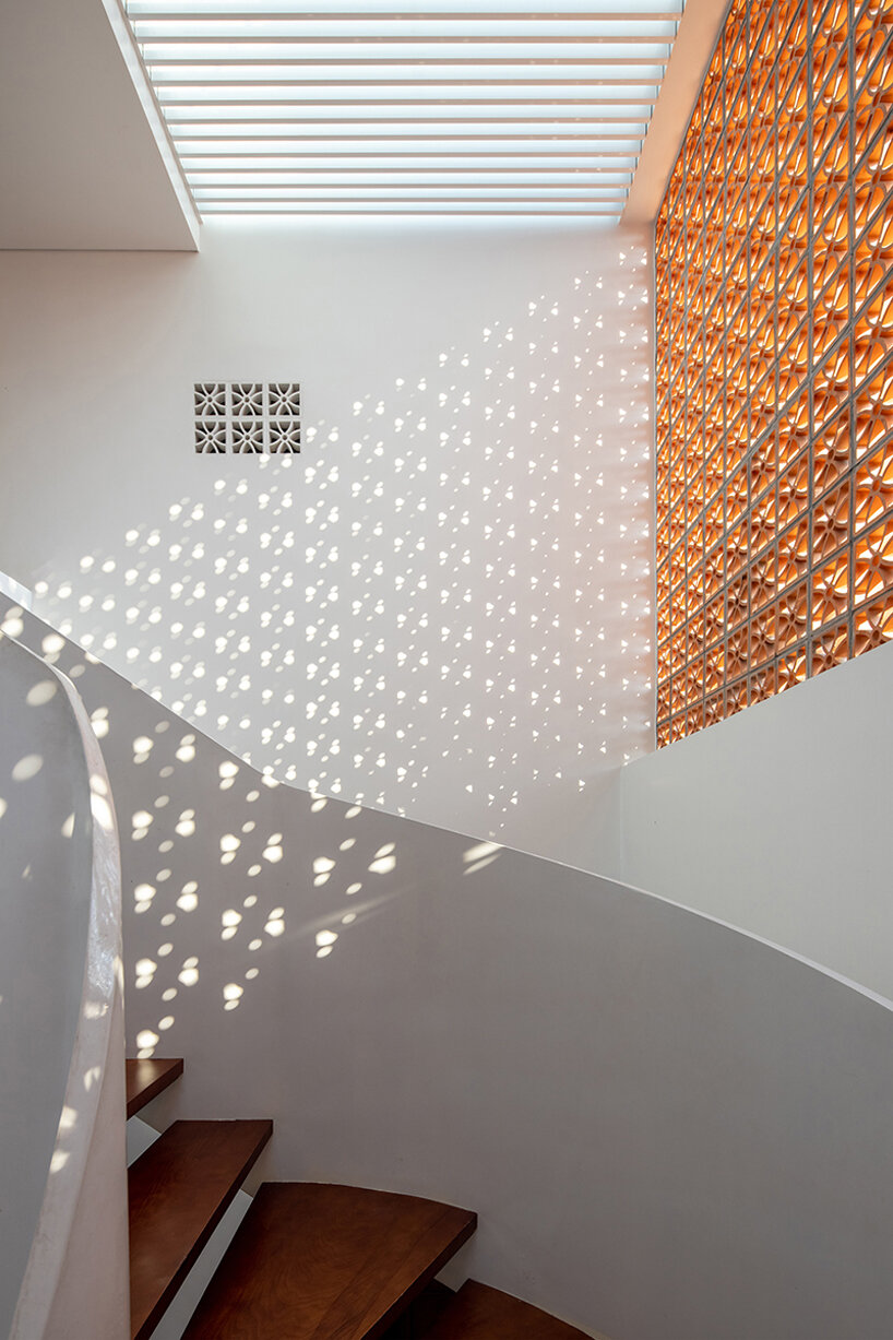 perforated double-skin brick facade shields grand house in vietnam