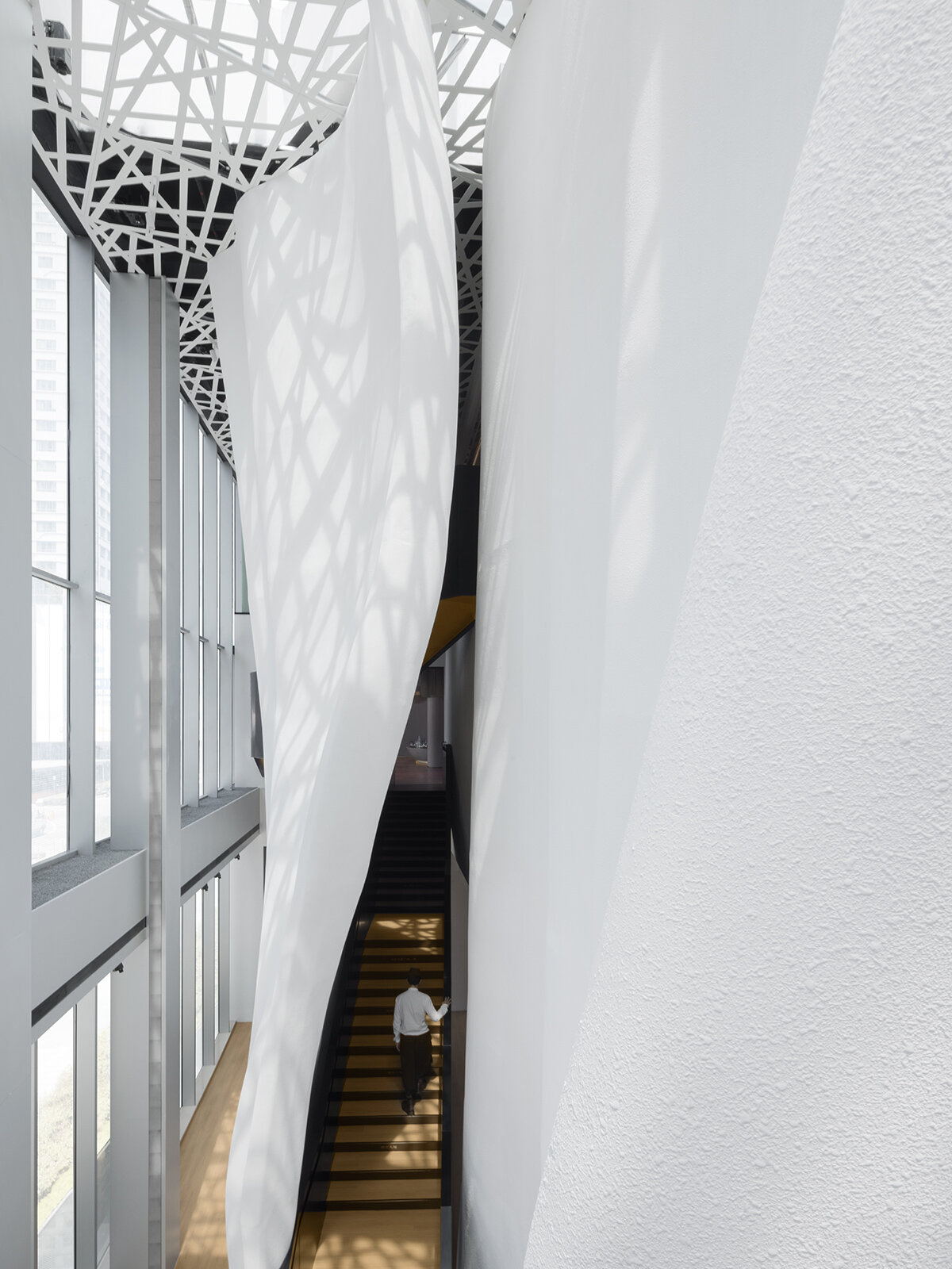 the veil: groundwork sculpts sinuous architecture like draped fabric