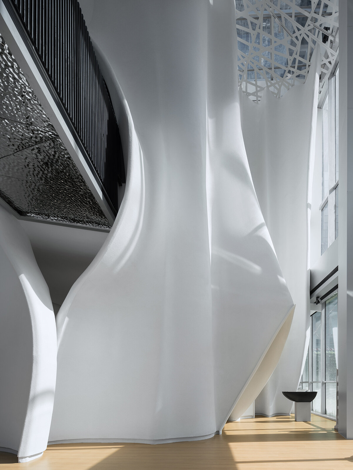 the veil: groundwork sculpts sinuous architecture like draped fabric