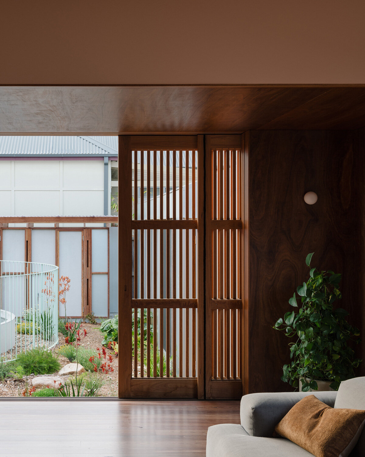 curious practice revives 'aru house' with brickwork & timber screens