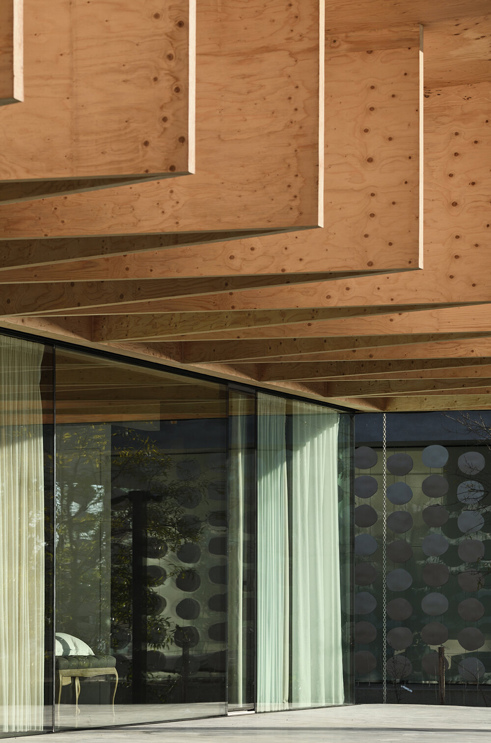 jagged wooden structure unfolds on top of ba holz house sitting along ...