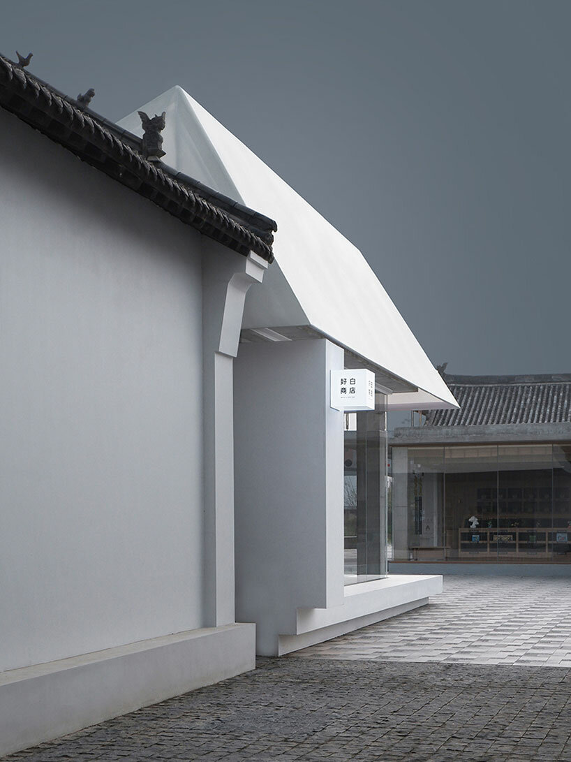 translucent pitched roof tops glass-clad store by designRESERVE in ...