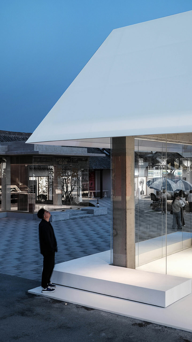 translucent pitched roof tops glass-clad store by designRESERVE in ...