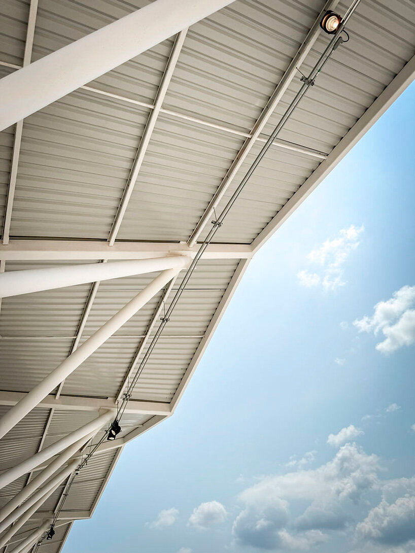 modular metal shell rests atop aidia studio's revamped sports center