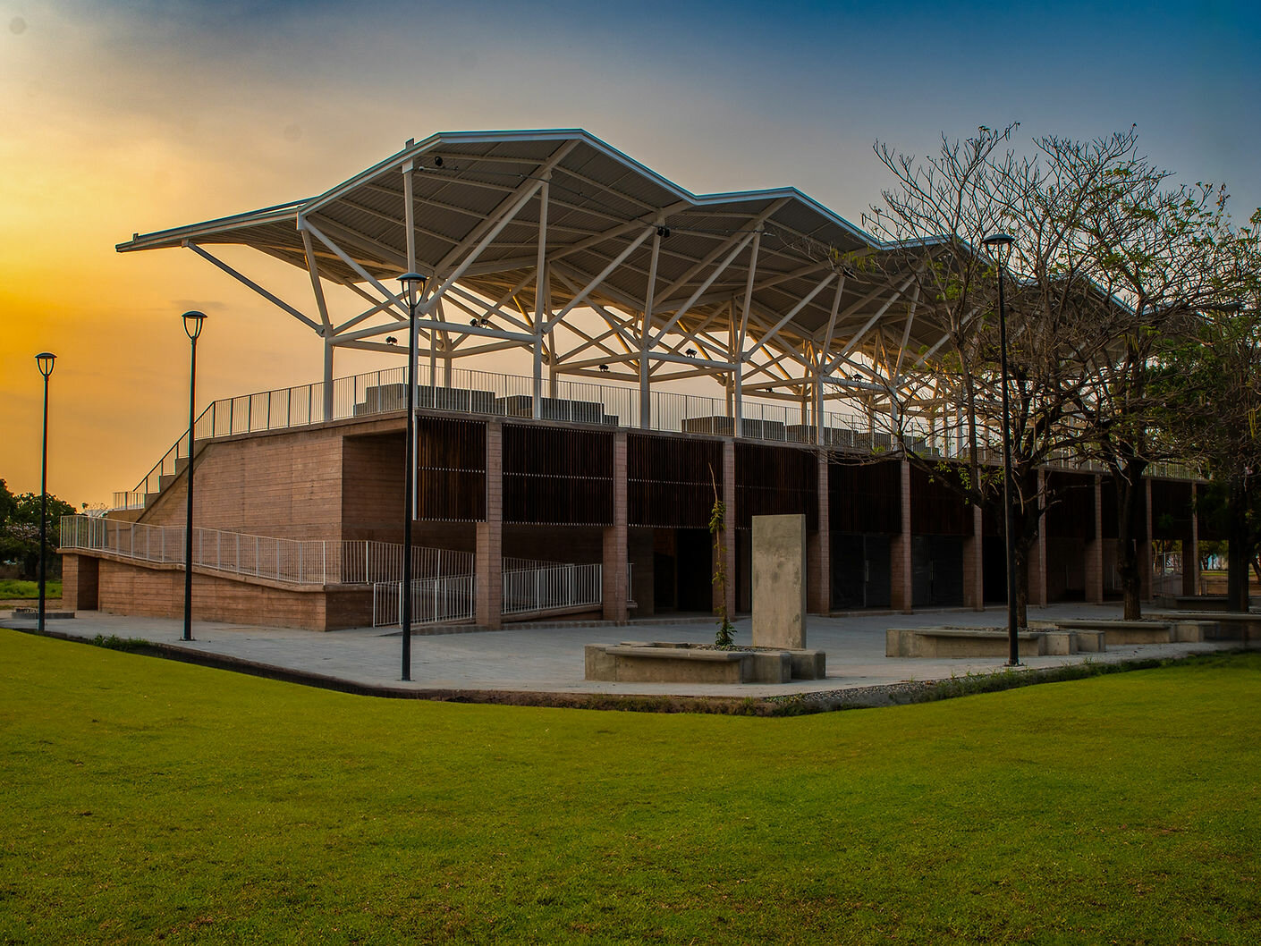modular metal shell rests atop aidia studio's revamped sports center