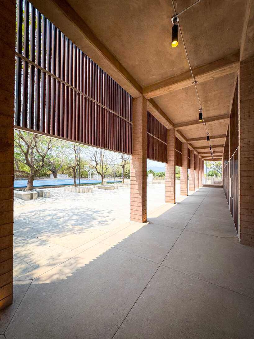 modular metal shell rests atop aidia studio's revamped sports center