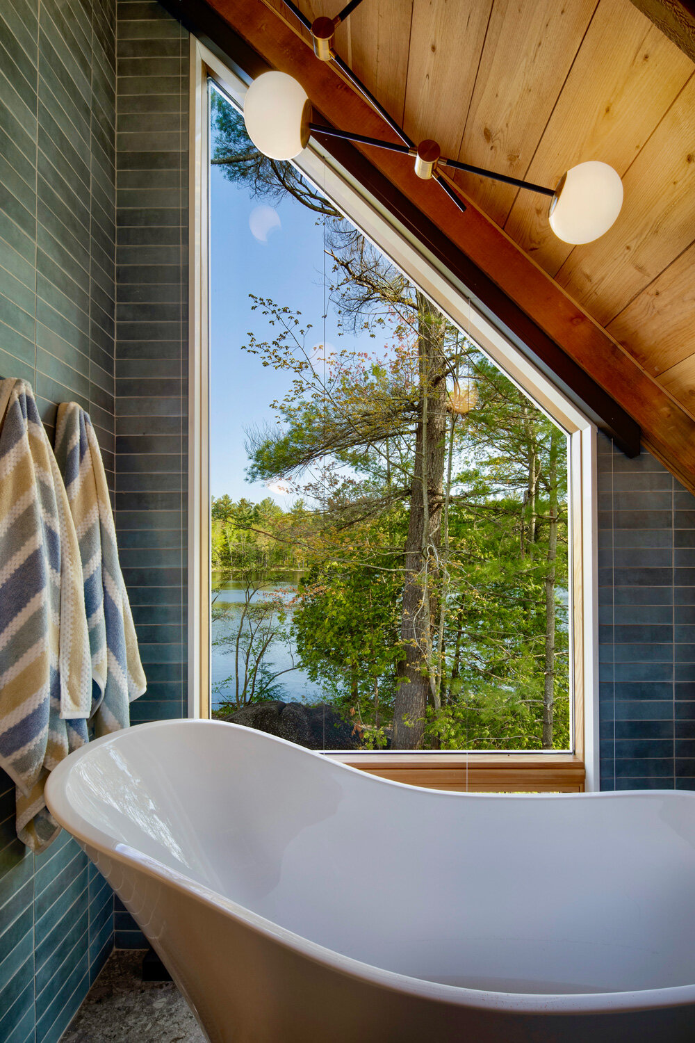 undulating shoreline envelops six mile lake cottage by BLDG workshop