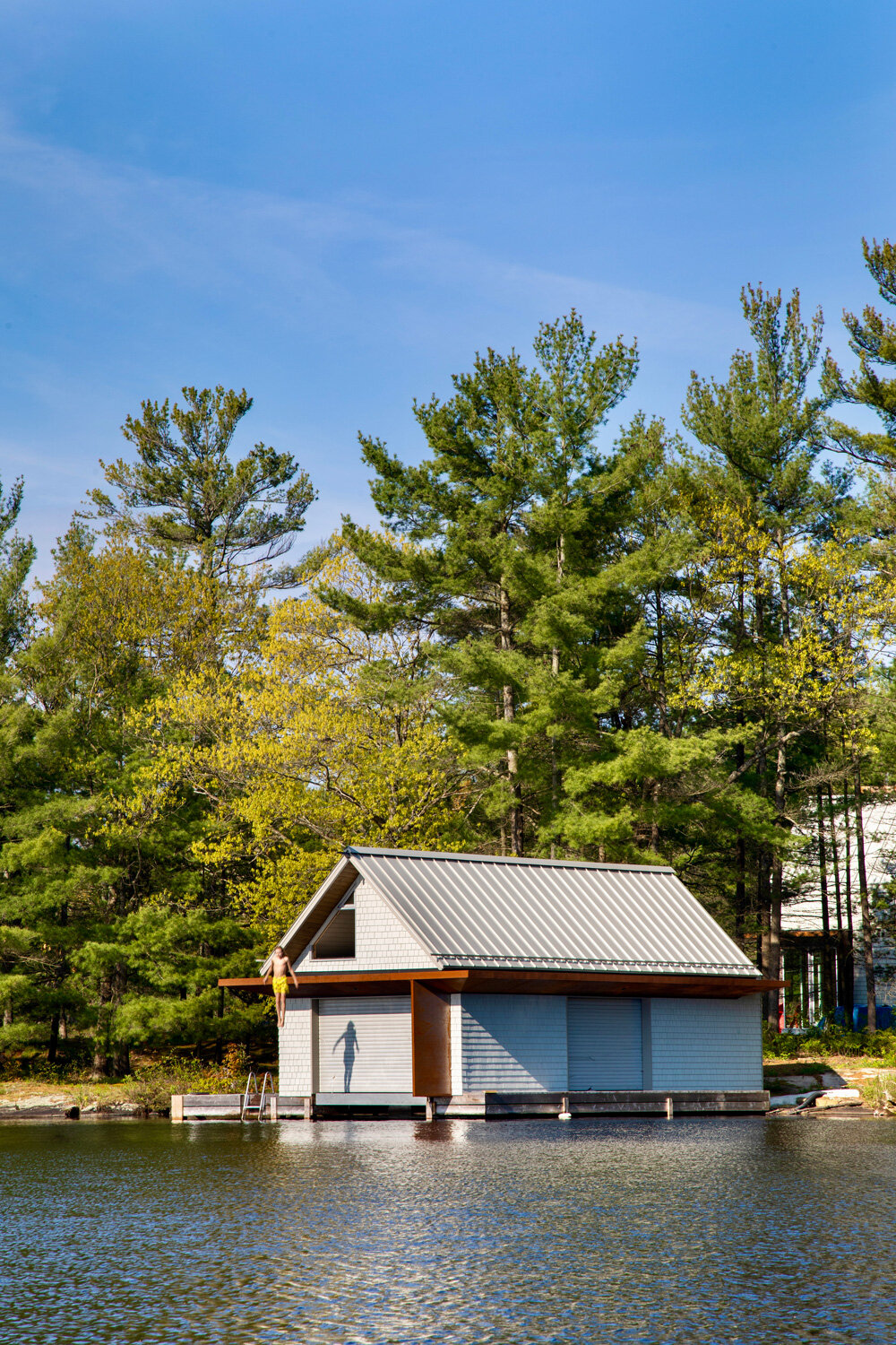undulating shoreline envelops six mile lake cottage by BLDG workshop
