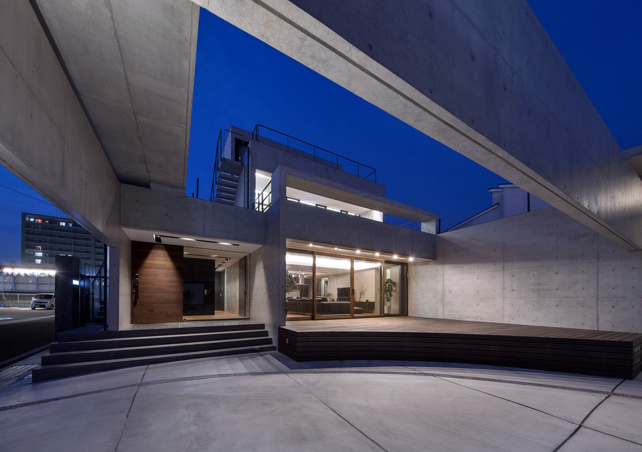 concrete eaves and hanging walls encircle house in fukutsu city