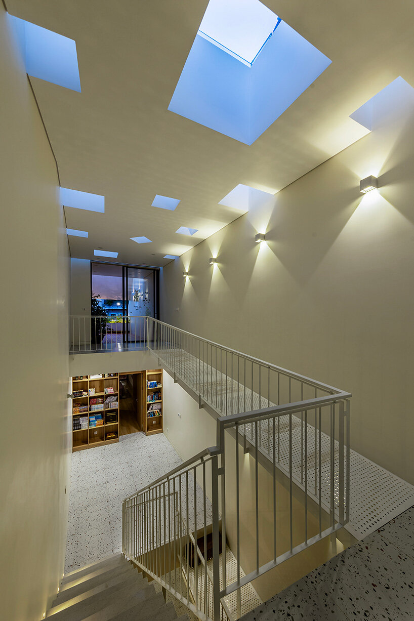 cutouts in slanted concrete roof illuminate vietnamese residence by DMA ...